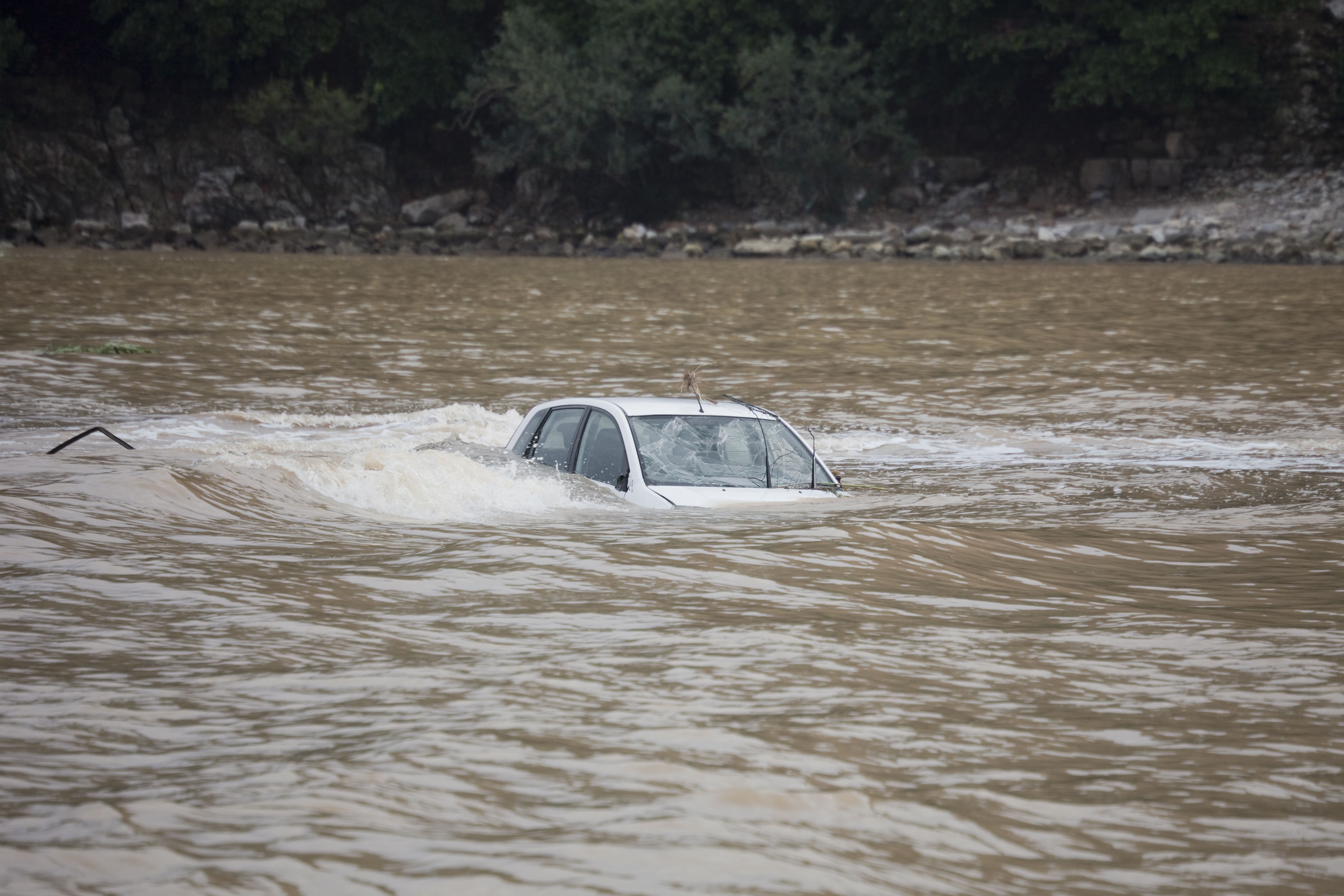 Tesla car in submarine mode driving through flood waters | Al Bawaba