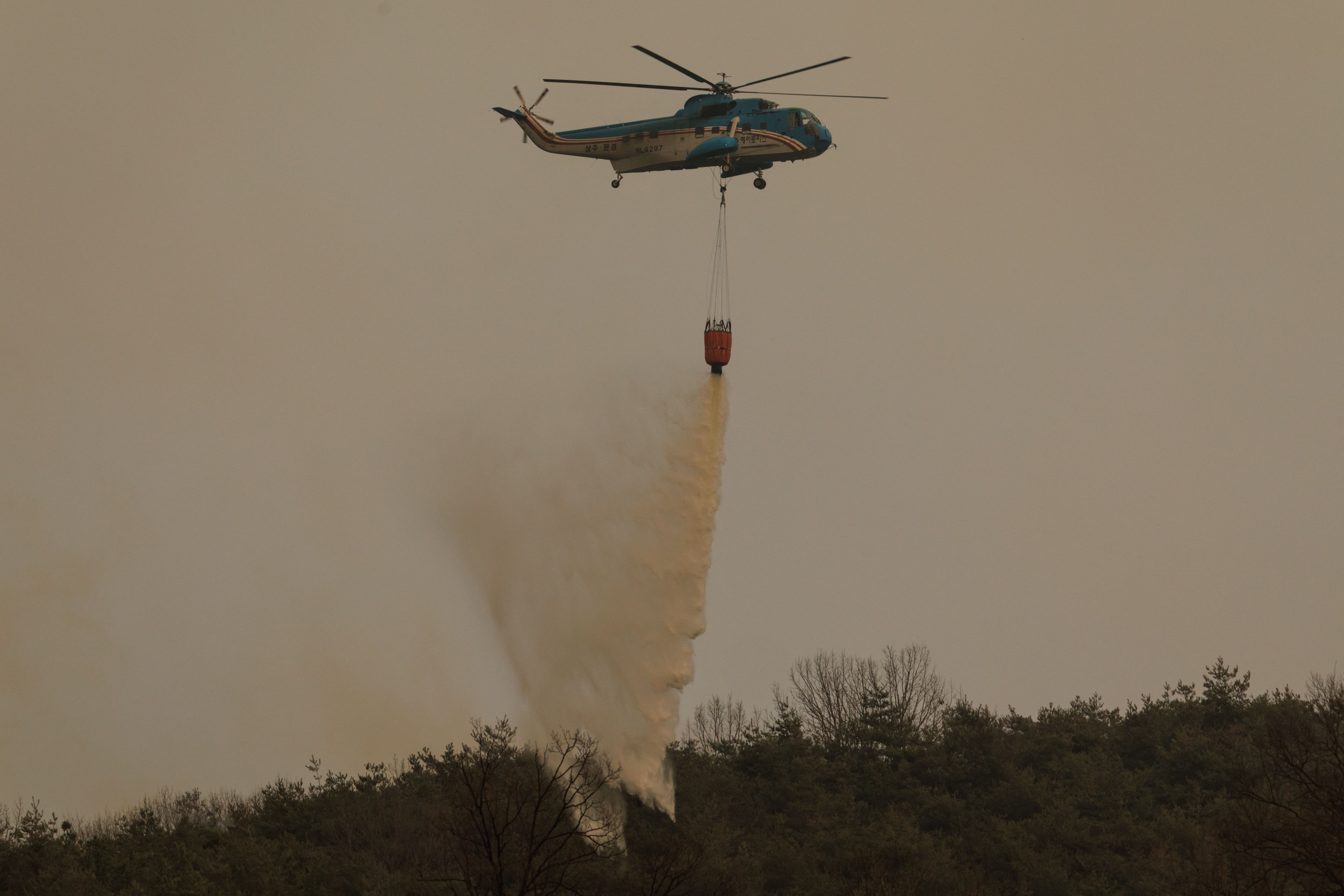 Helicopter crash kills firefighting pilot amid raging wildfires in ...