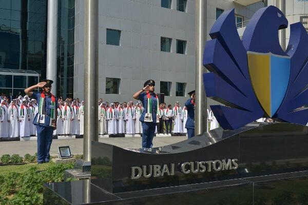 Dubai Customs officials and employees salute the UAE flag | Al Bawaba